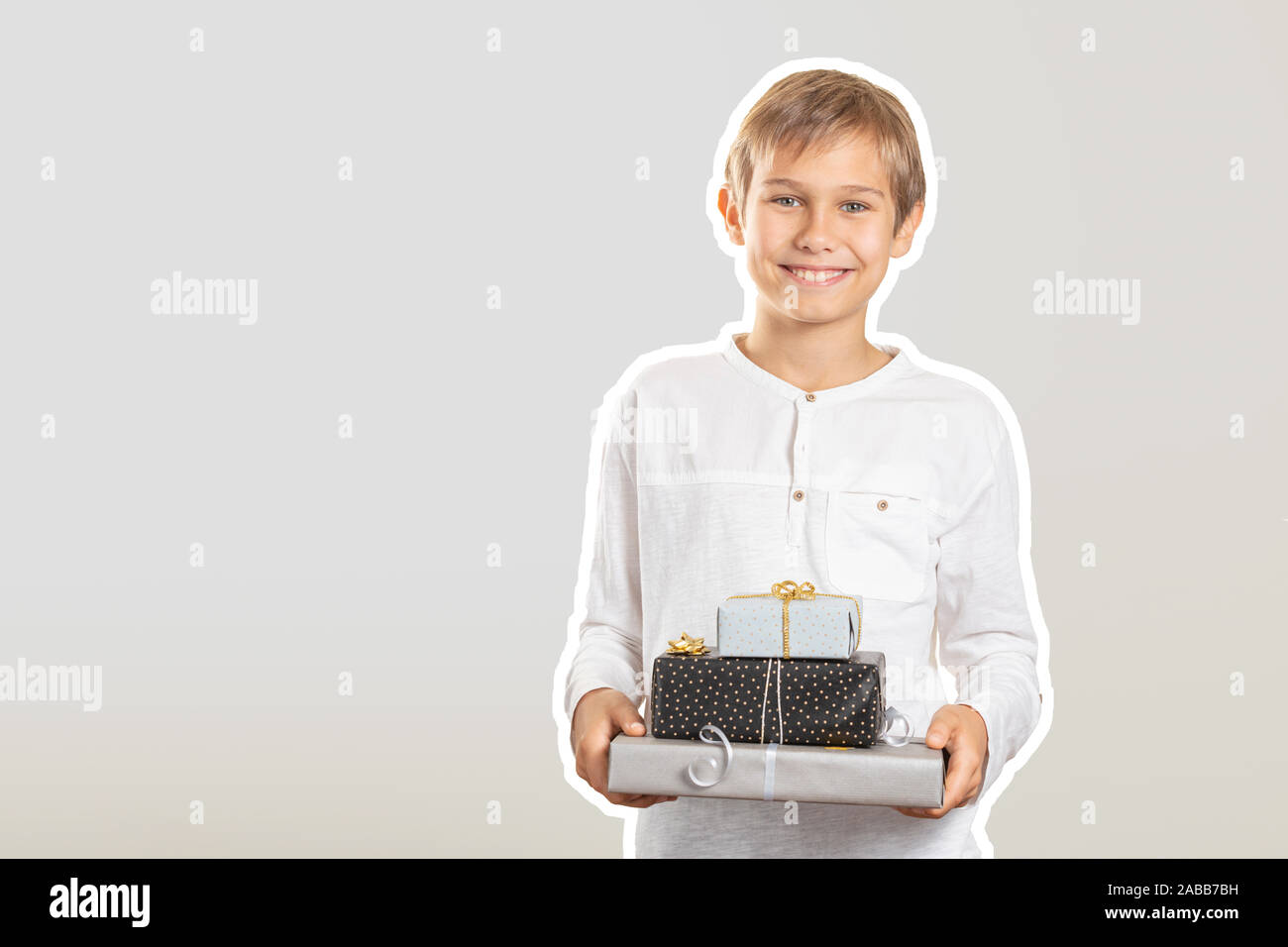 Happy boy holding stack paper wrapped present gift boxes. Magazine ...