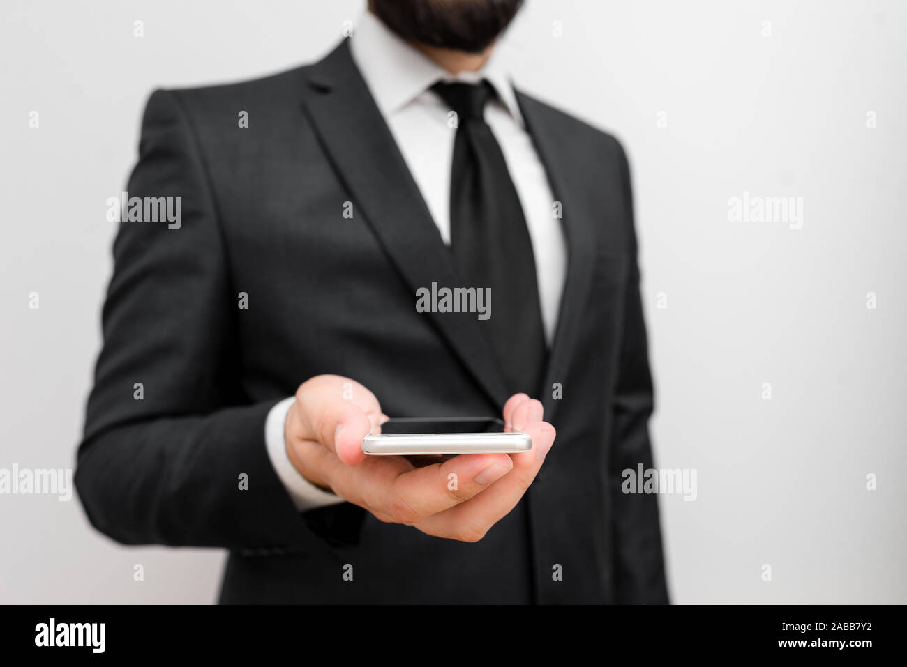 Male human wear formal work suit hold smart hi tech smartphone use one ...