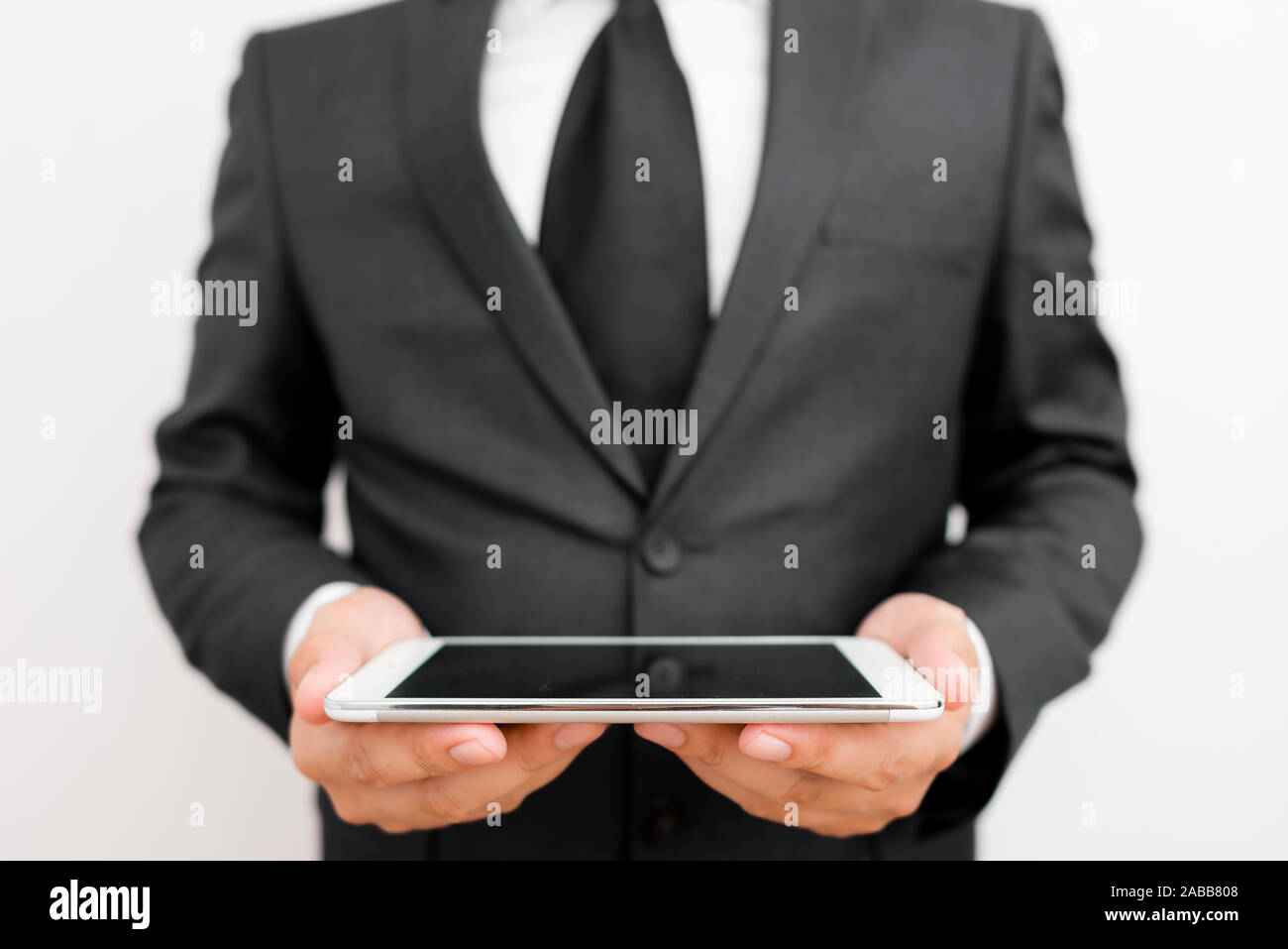 Male human wear formal work suit hold smart hi tech smartphone use ...