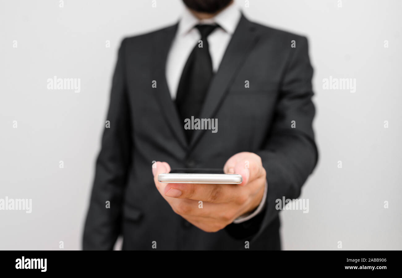 Male human wear formal work suit hold smart hi tech smartphone use one ...