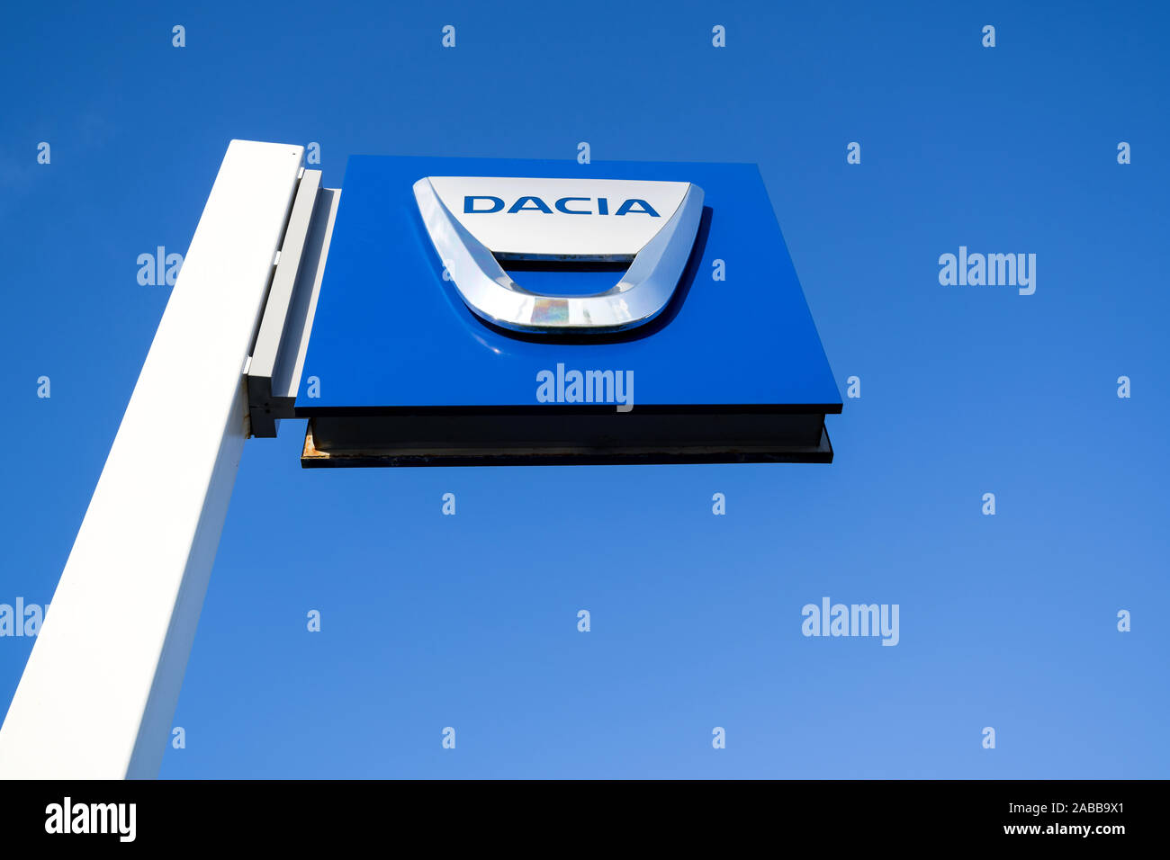Dacia dealership sign against blue sky Stock Photo - Alamy