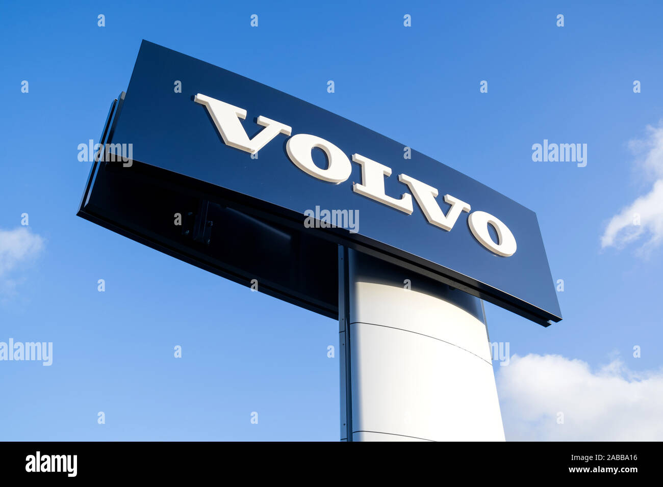 Volvo dealership sign against blue sky Stock Photo - Alamy