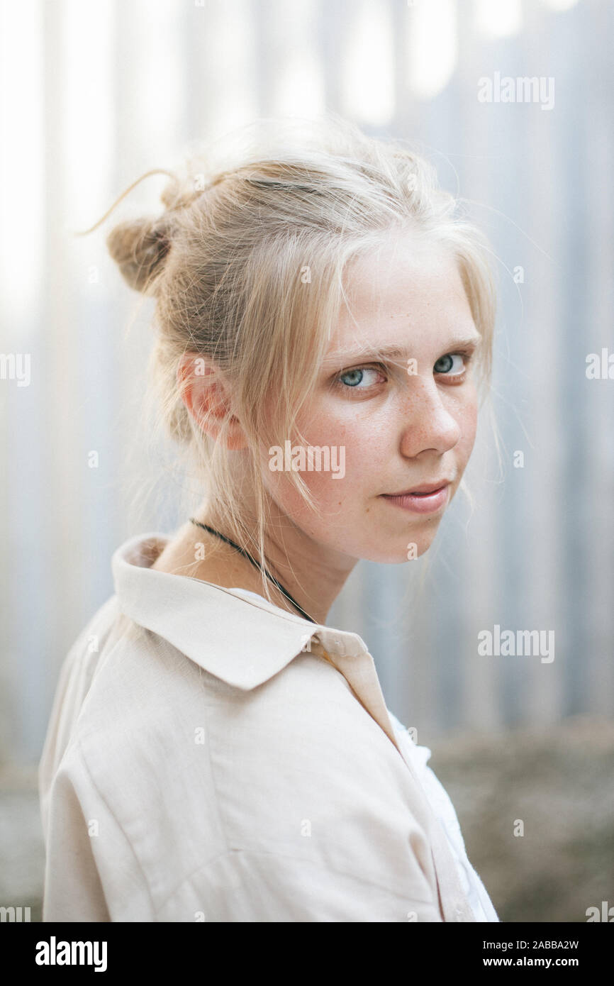 Portrait of a beautiful woman with a hair bun Stock Photo - Alamy