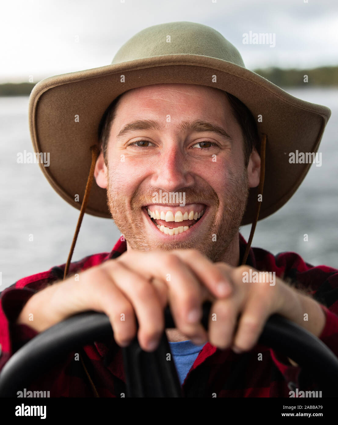 Man driving boat handsome hi-res stock photography and images - Alamy
