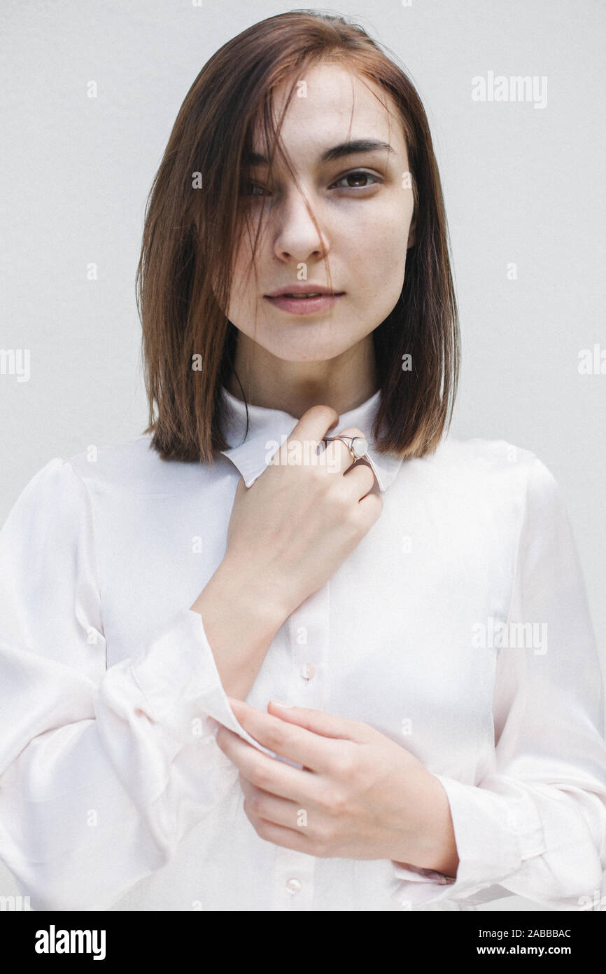 Woman Adjusting Shirt Collar Hi Res Stock Photography And Images Alamy
