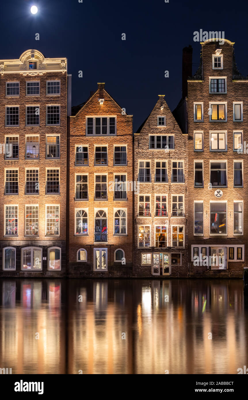 Traditional Dutch buildings at Damrak at night, Amsterdam, Netherlands ... Traditional Dutch buildings at Damrak at night, Amsterdam, Netherlands ...