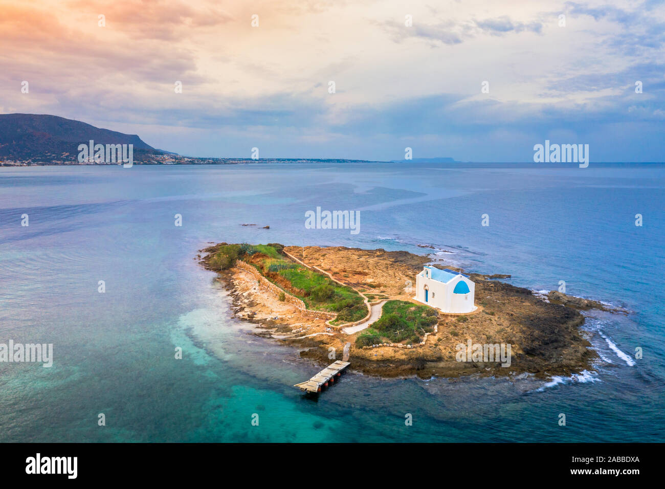 An old white church in a small island at sunset in Malia, Crete, Greece ...