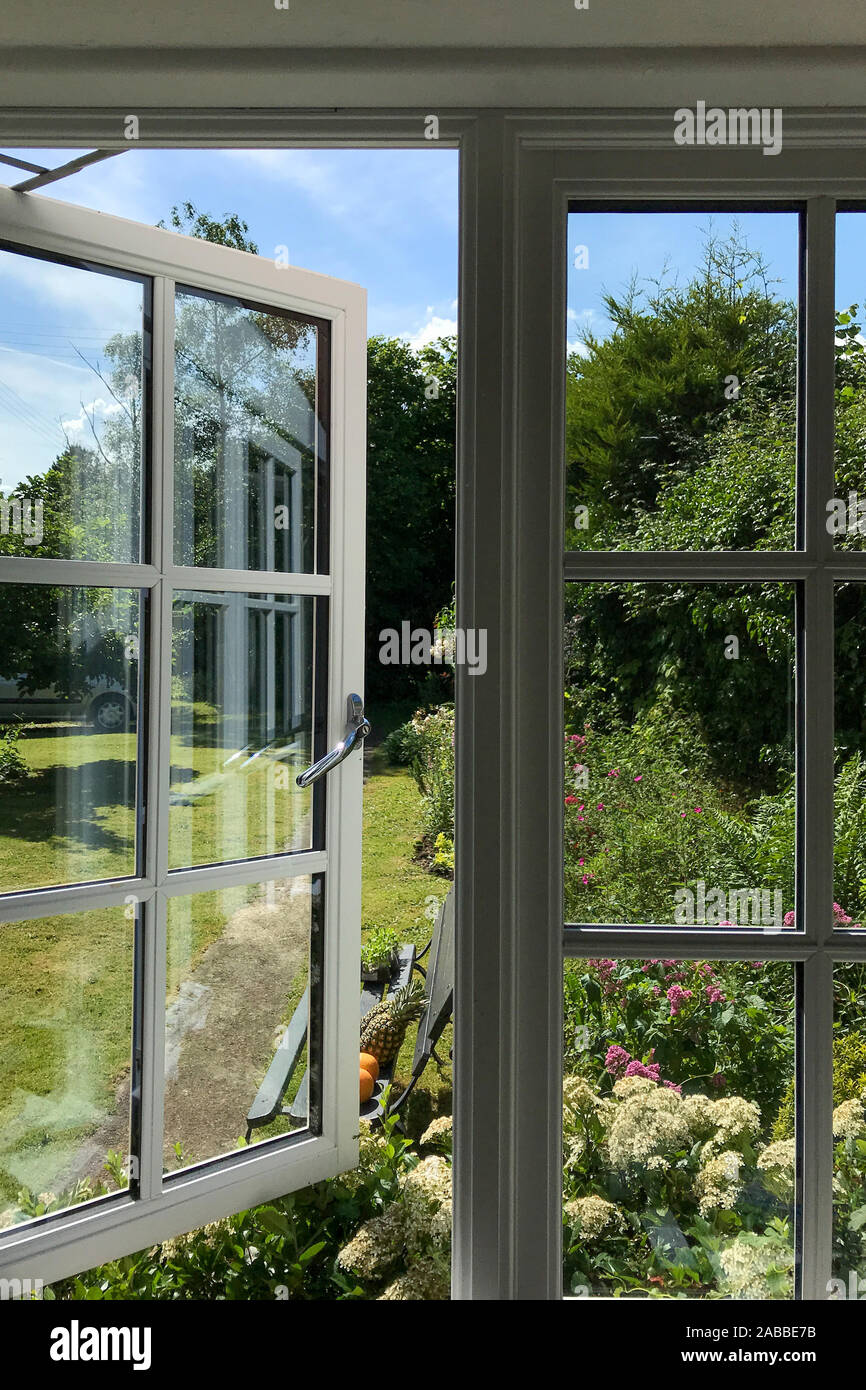View of a country garden through a window, England, UK Stock Photo - Alamy