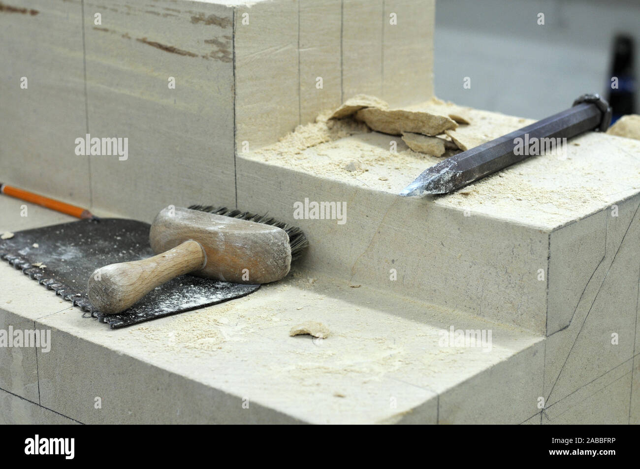 block of sandstone in a stonemason workshop with chisel and brush Stock ...