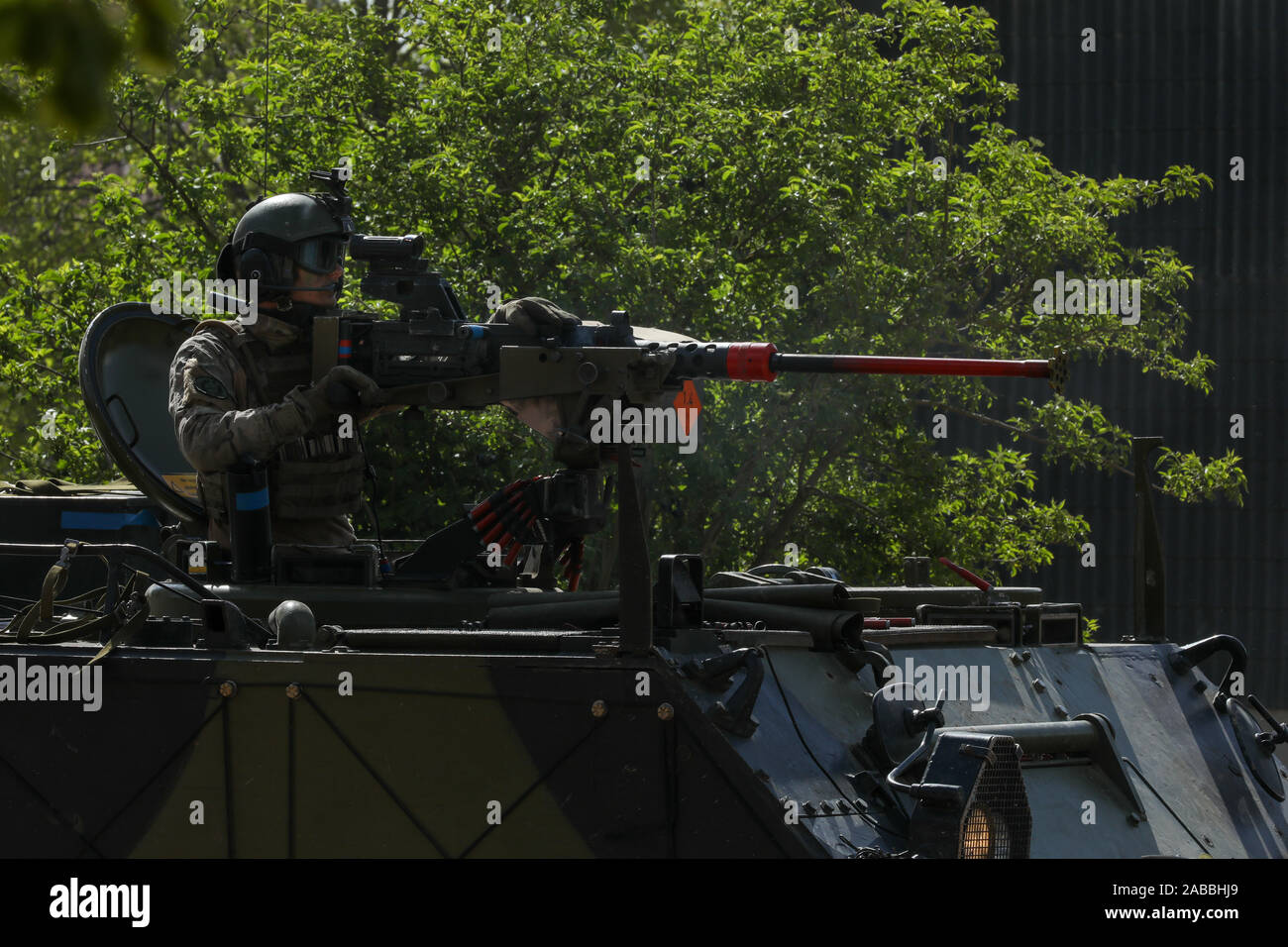 Latvian Army soldier manning a HMG (heavy machine gun) on Armoured ...