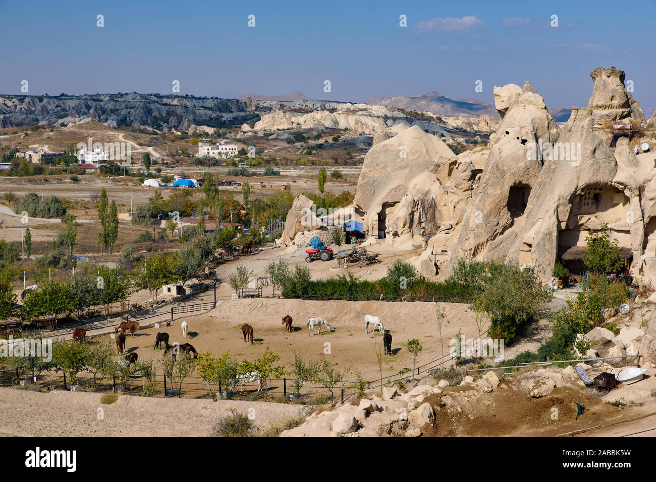 Farm surrounded by cave houses carved in stone at Göreme, Cappadocia ...