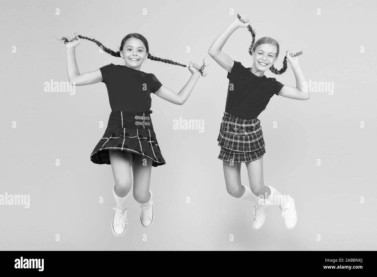 Join celebration. Cheerful friends schoolgirls jumping yellow ...