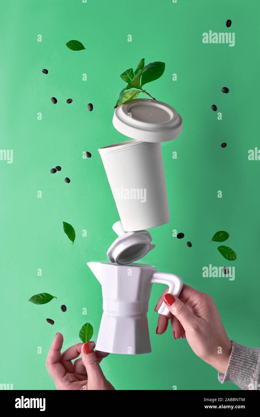 Balancing zero waste coffee pyramid in female hands on neo mint ...