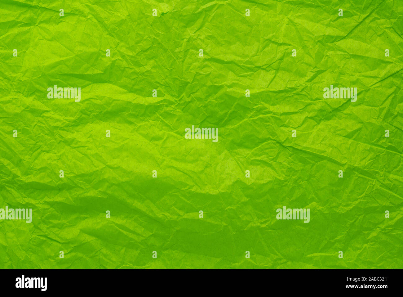 grunge, crumpled, wrinkled and creased bright green tissue paper ...