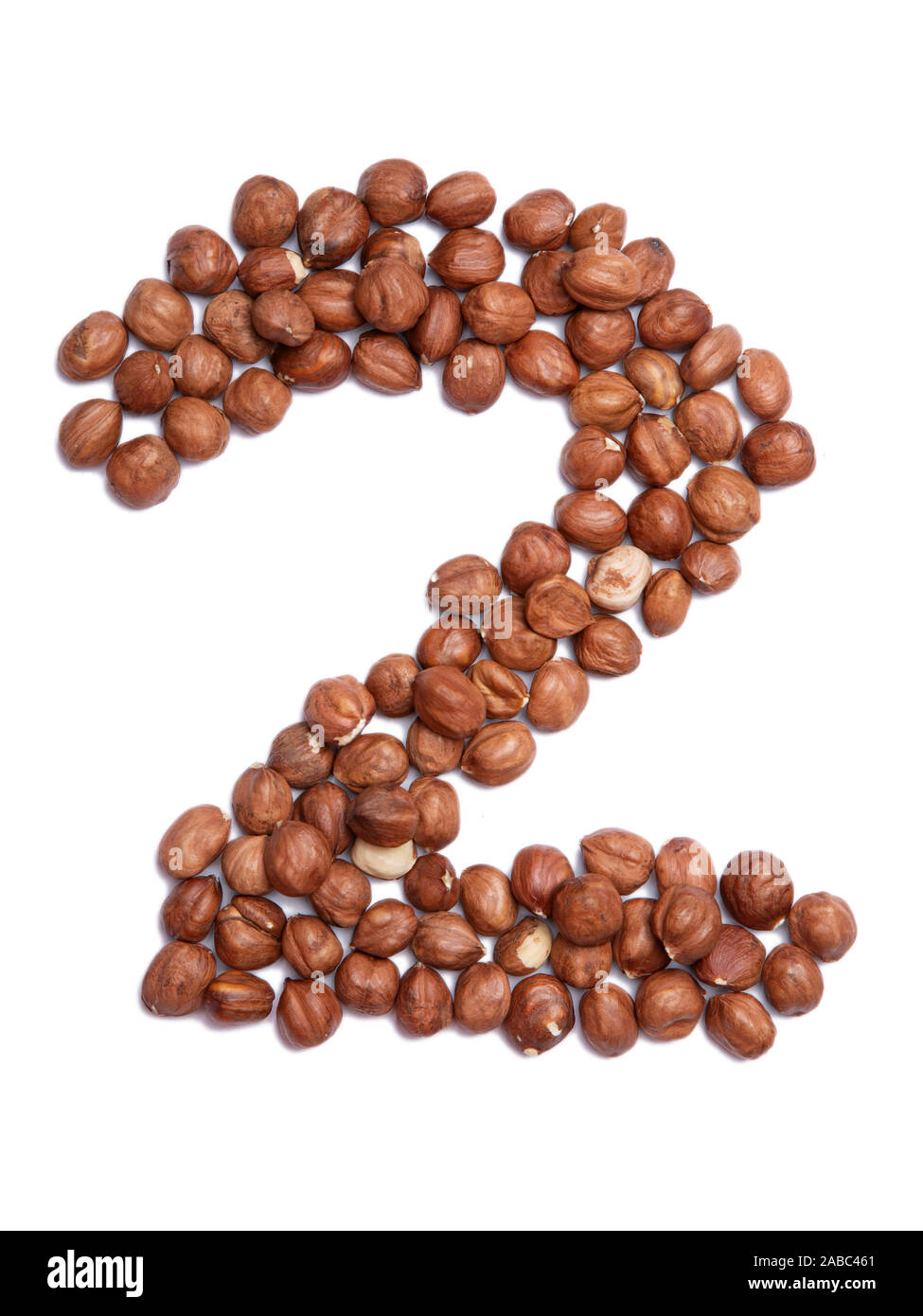Arabic numeral "2" from peeled hazelnut on a white isolated background ...