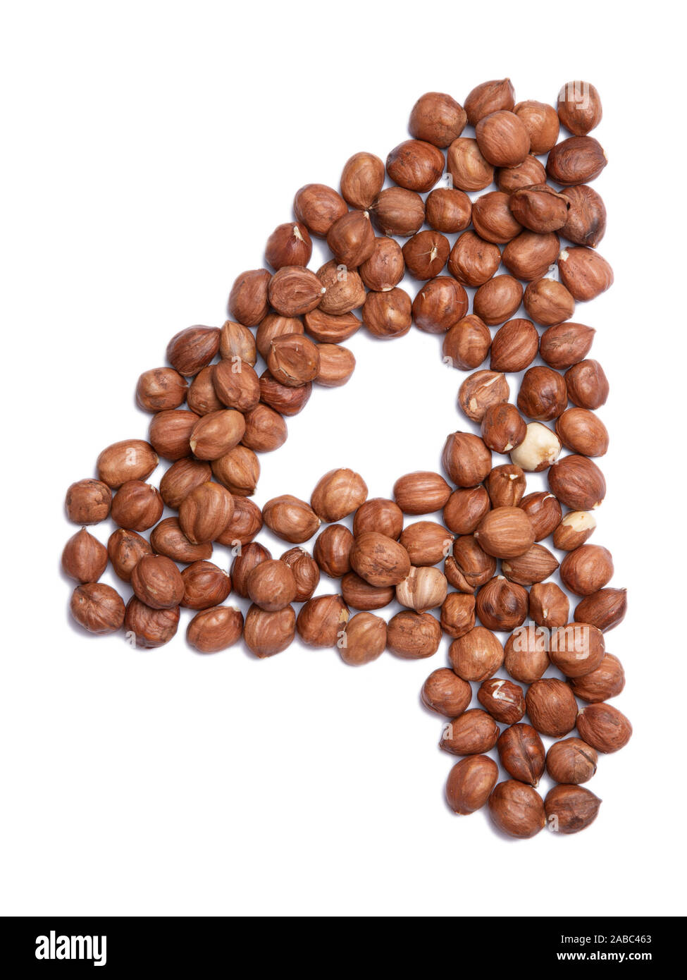 Arabic numeral "4" from peeled hazelnut on a white isolated background ...