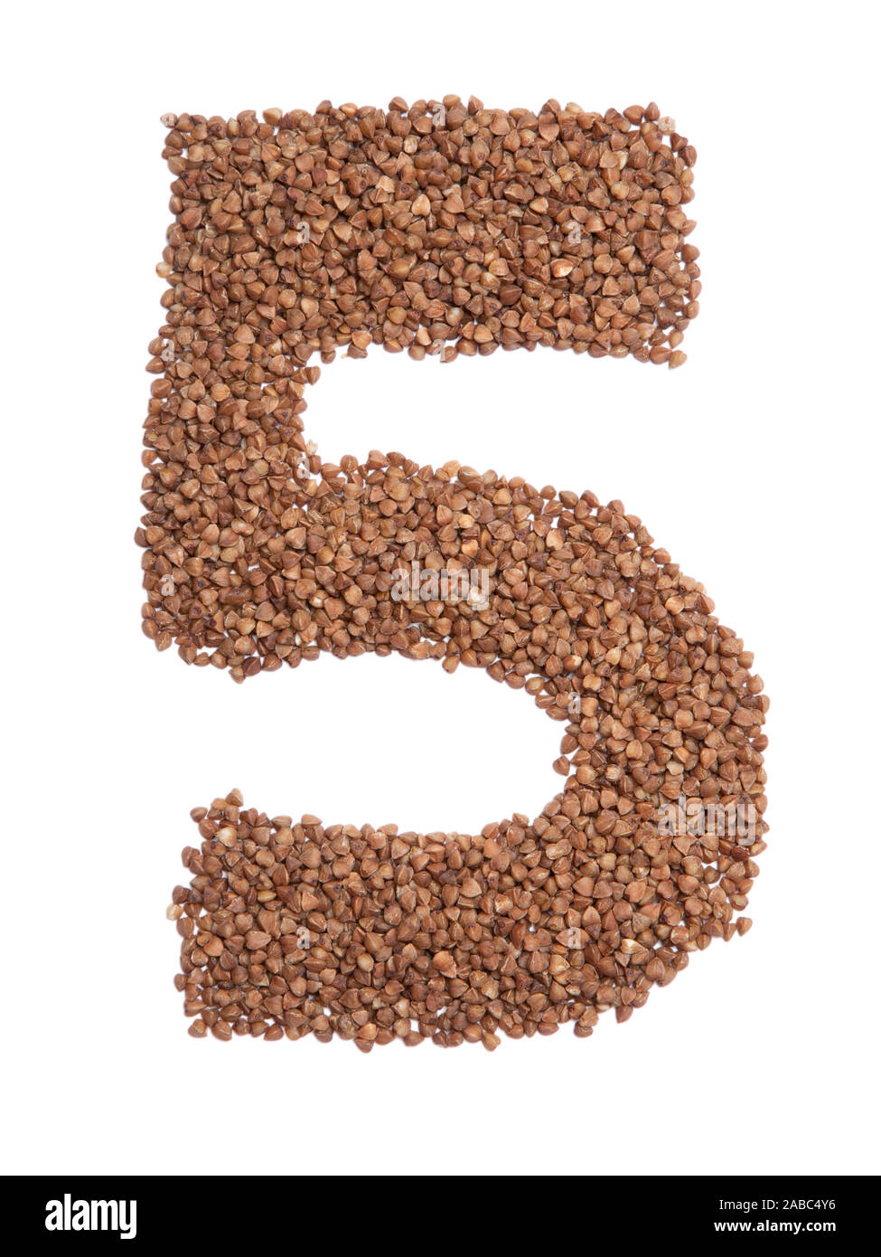 Arabic numeral "5" from brown dry buckwheat on a white isolated ...