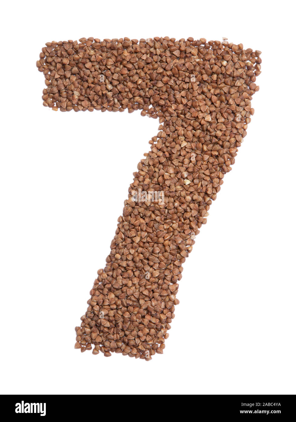 Arabic numeral "7" from brown dry buckwheat on a white isolated ...