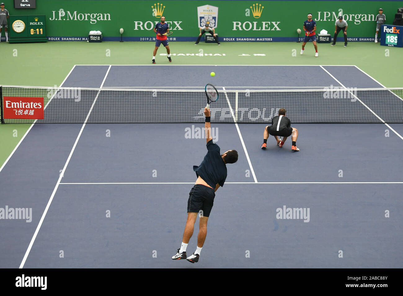 Mate Pavic of Croatia and Bruno Soares of Brazil, the far end, compete ...