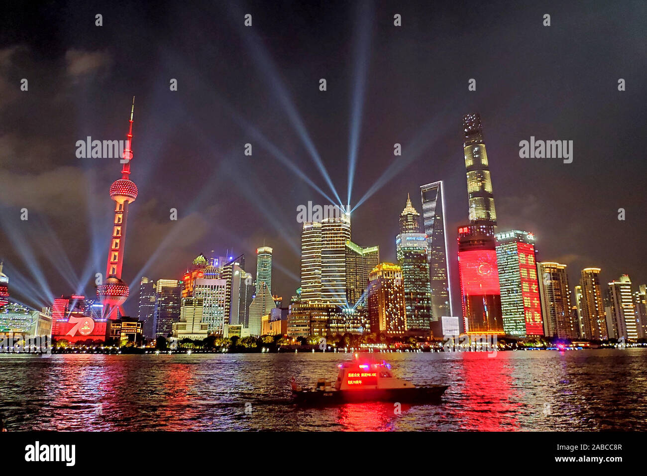 Tourists gather at the Bund to enjoy the light show performed with ...