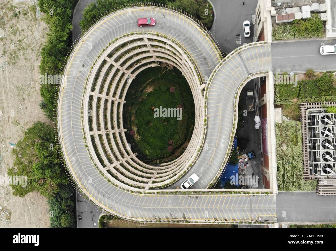 A car drives on the circular parking lot in a community in Hangzhou ...