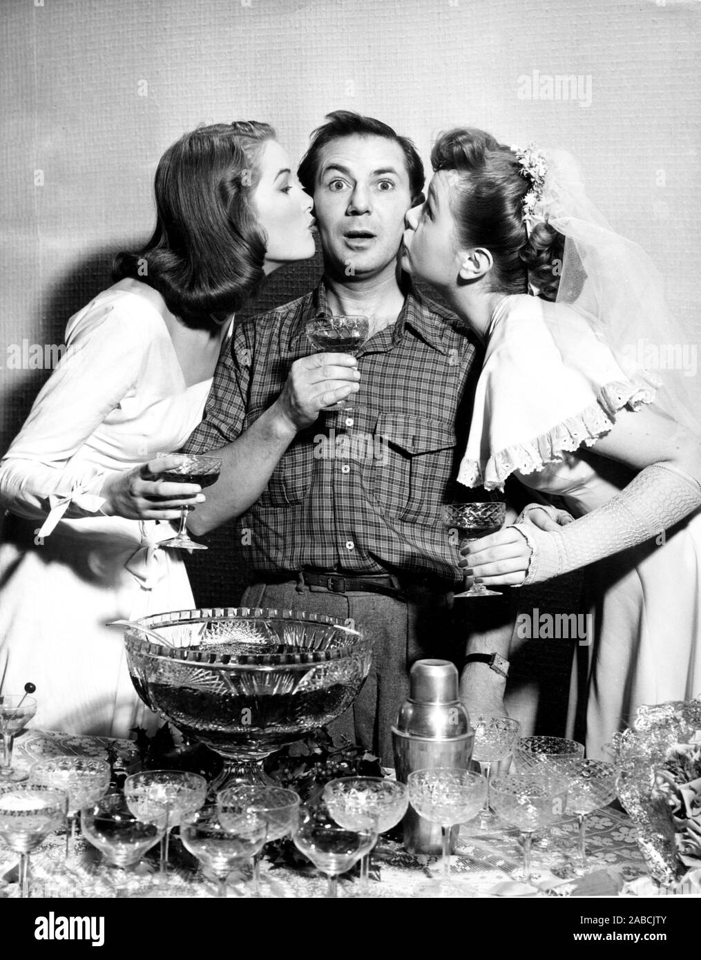 FOOLS RUSH IN, director John Paddy Carstairs is smooched on-set by ...