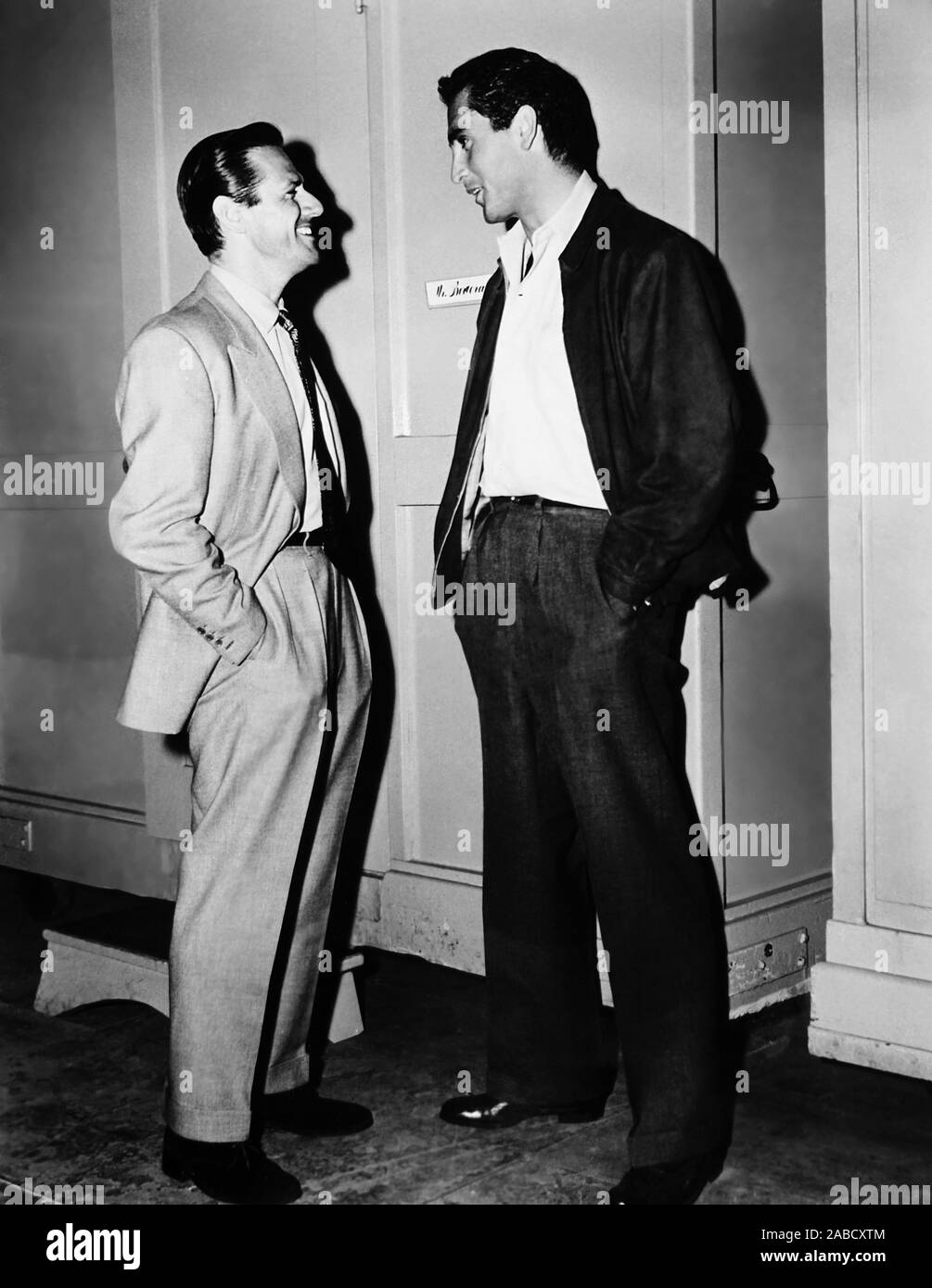 LES GIRLS, from left: Mario Cabre visiting Jacques Bergerac on set ...