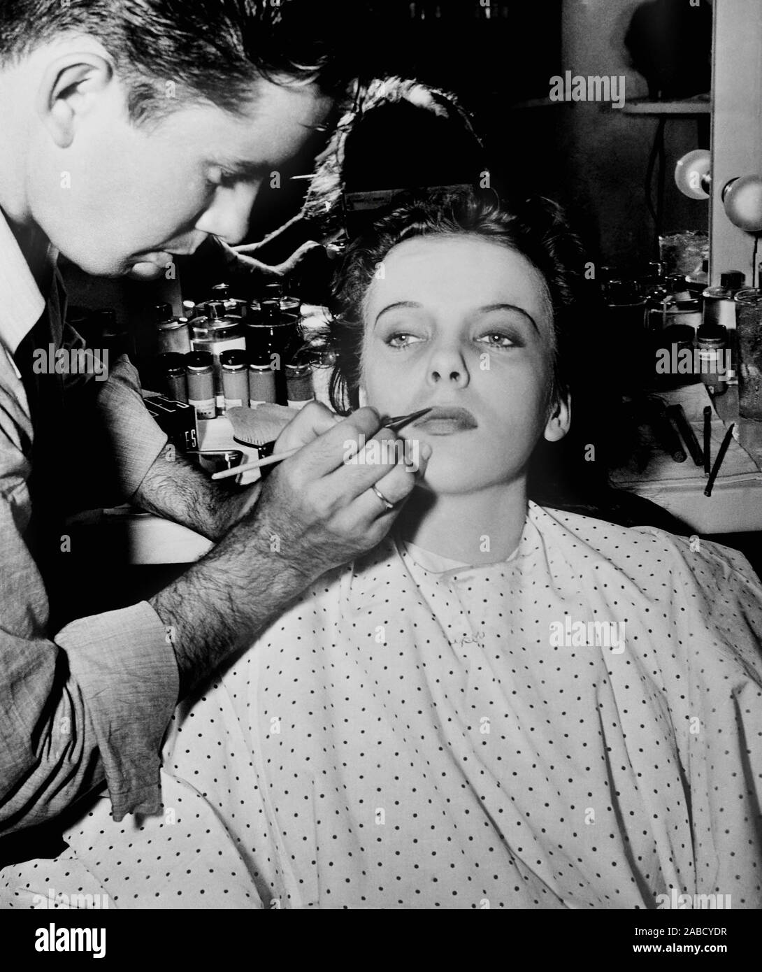 THE LIGHT THAT FAILED, from left: makeup artist Bud Westmore working on ...