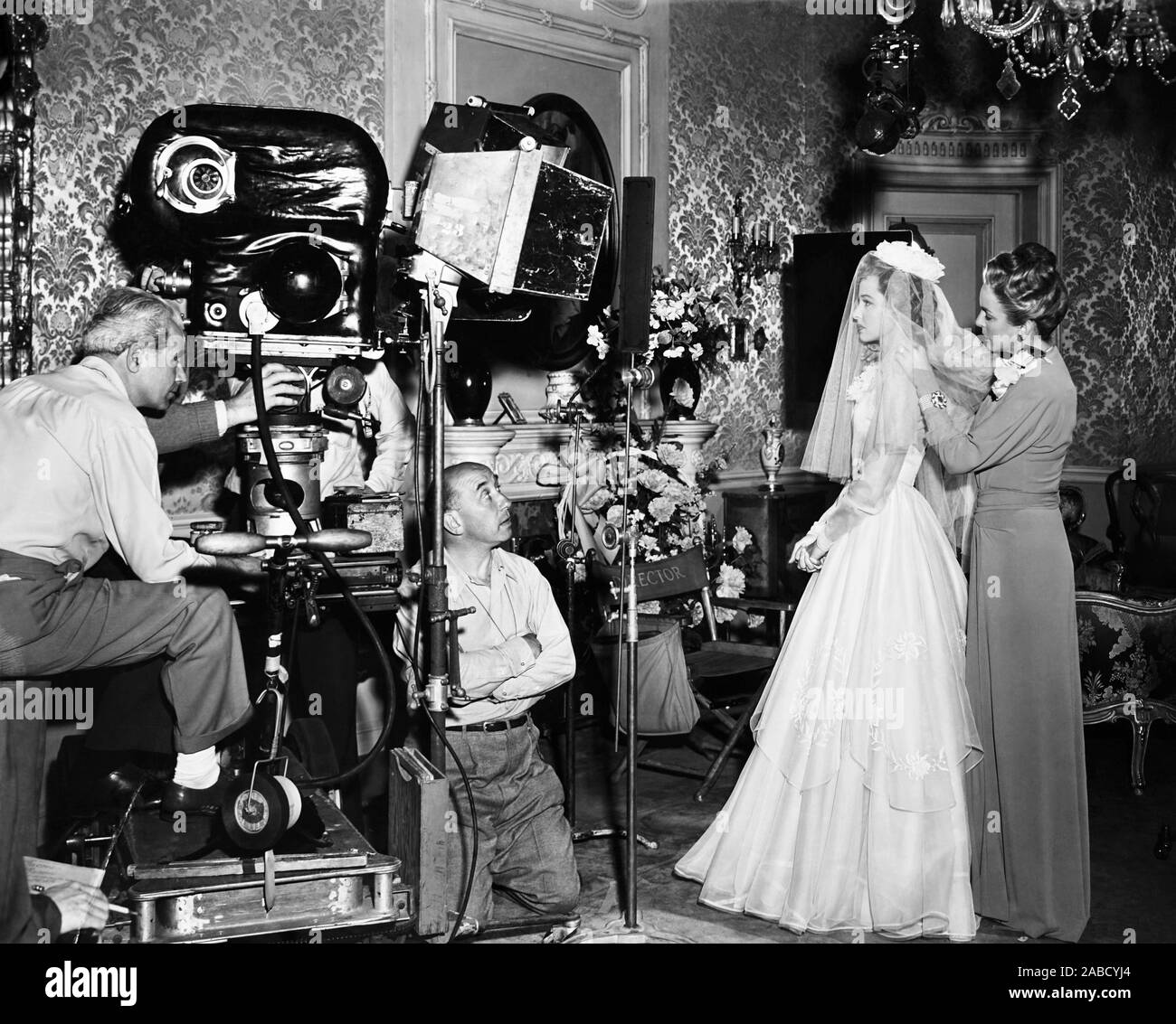 THE LOCKET, director John Brahm (kneeling), Laraine Day (in wedding ...