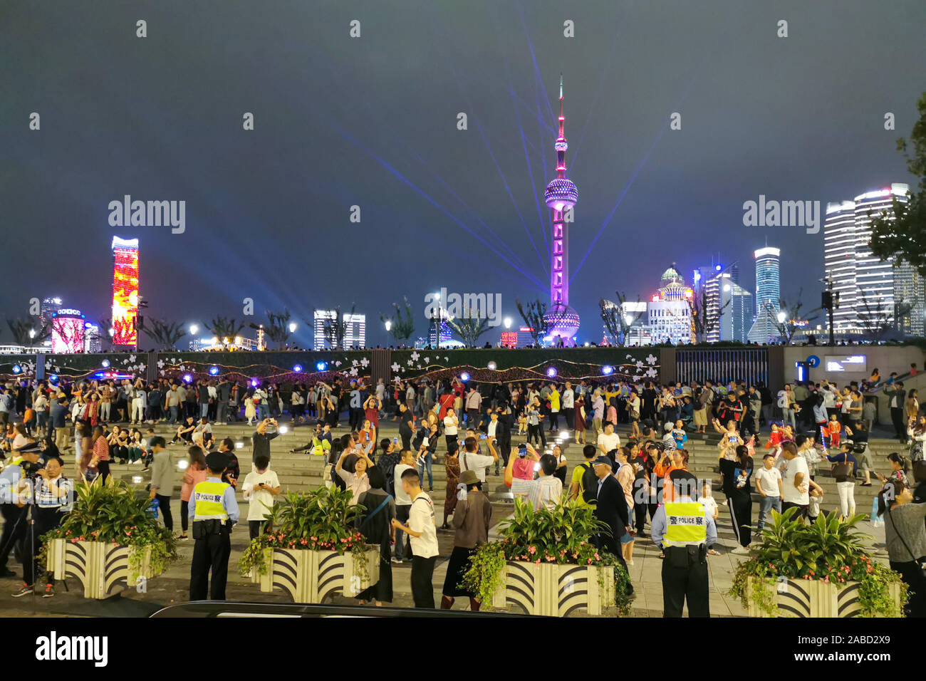 Tourists gather at the Bund to enjoy the light show performed with ...