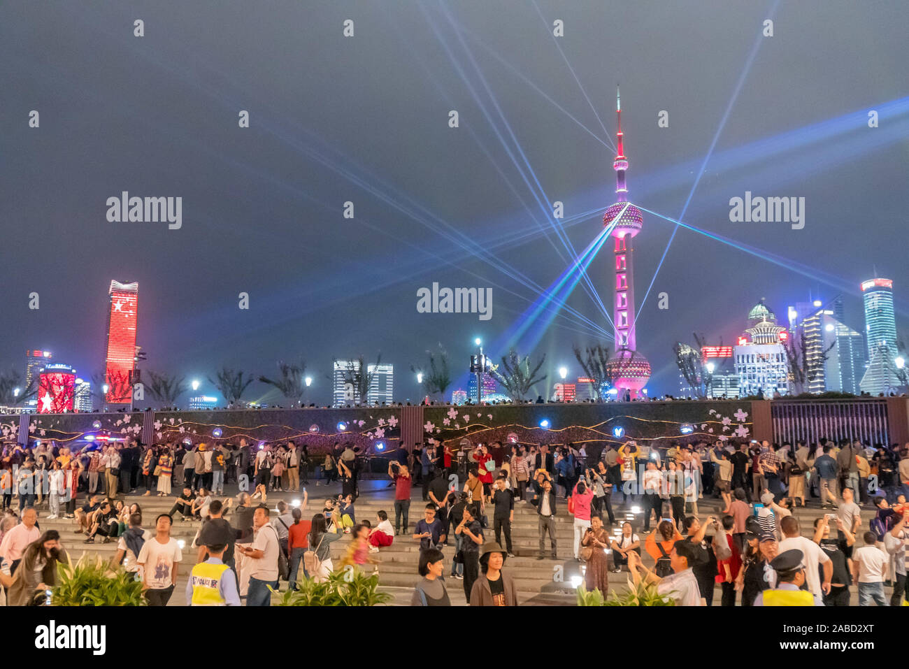 Tourists gather at the Bund to enjoy the light show performed with ...