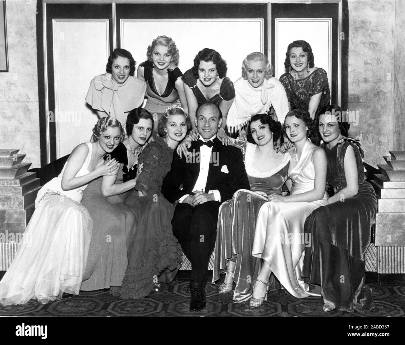 MURDER AT THE VANITIES, Earl Carroll with the showgirls he's chosen for ...