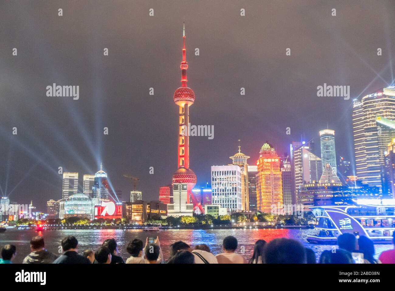 Tourists gather at the Bund to enjoy the light show performed with ...