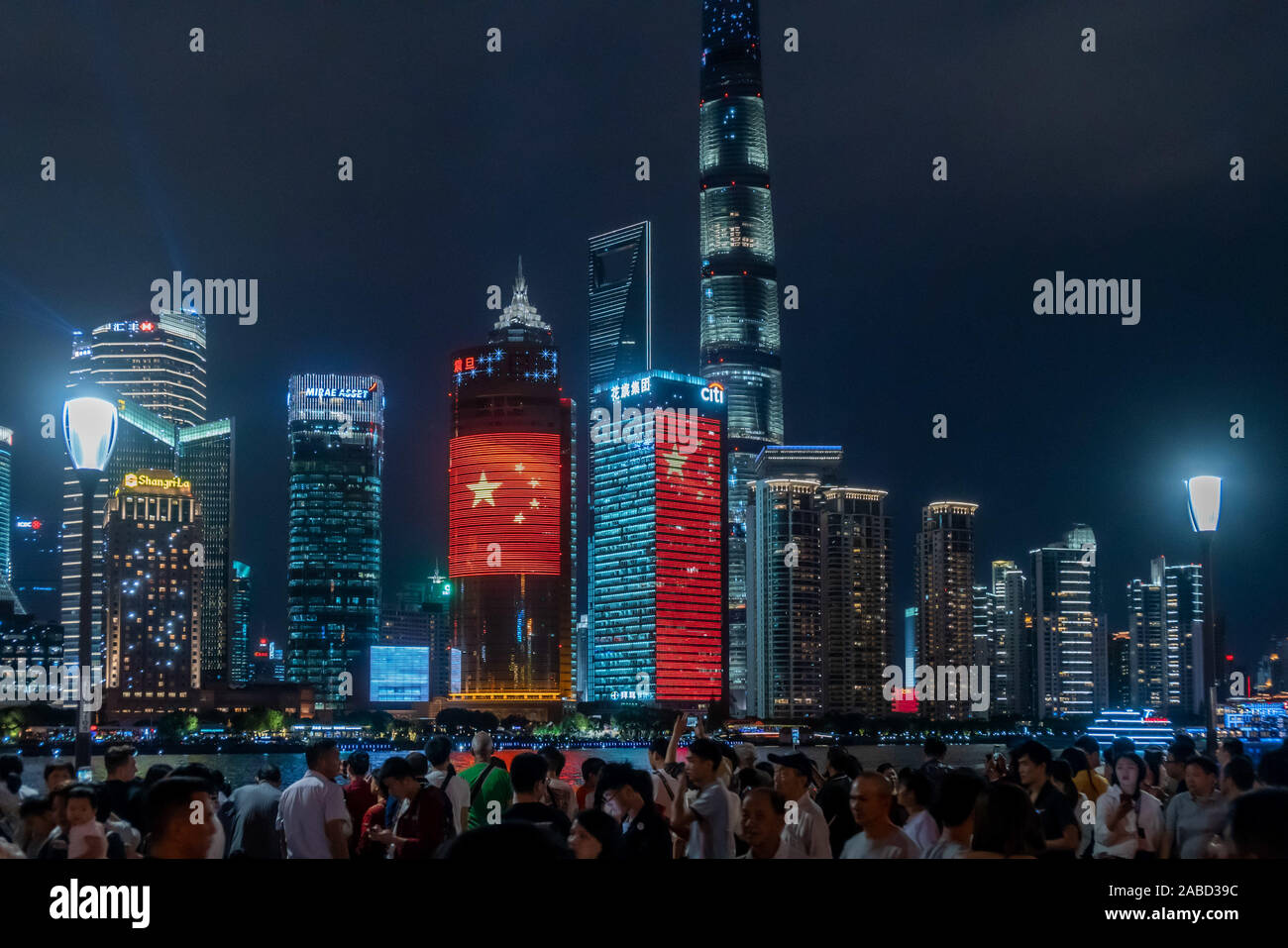 Tourists gather at the Bund to enjoy the light show performed with ...