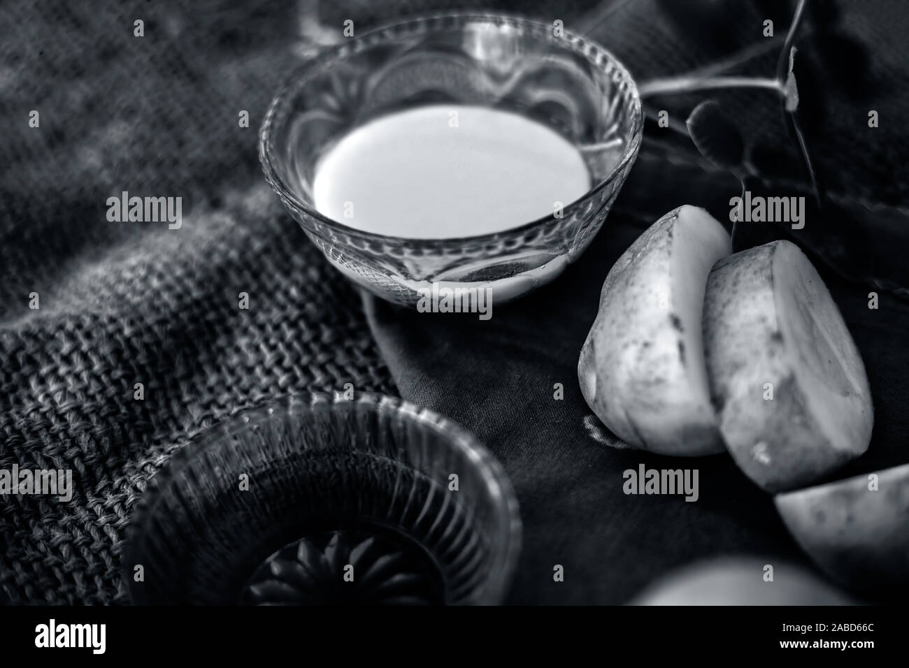 Potato juice's face pack or face mask in a glass bowl on jute bag's ...