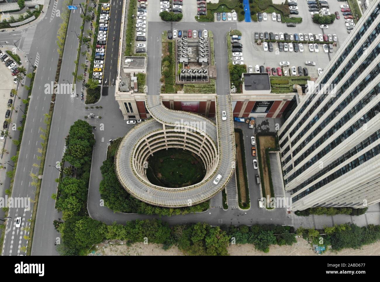 A car drives on the circular parking lot in a community in Hangzhou ...