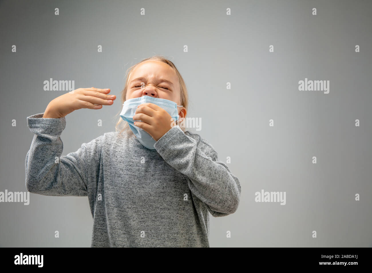 Can't breathe. Caucasian little girl wearing the respiratory protection ...
