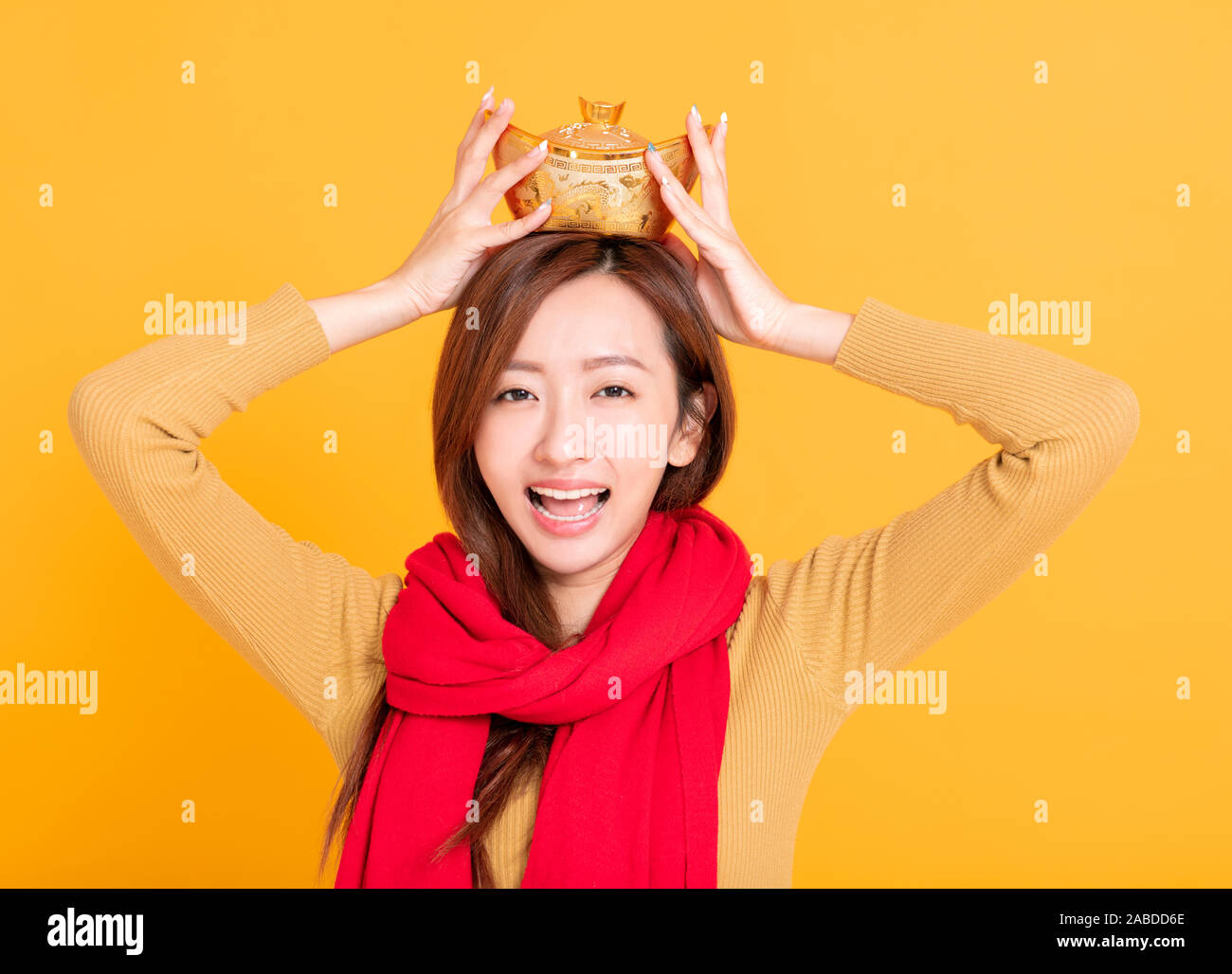 Beautiful asian young woman showing chinese gold ingot and celebrating ...