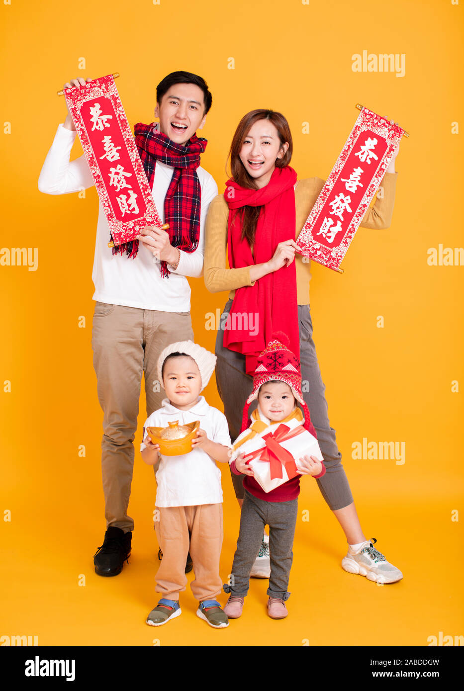 happy asian family celebrating chinese new year. chinese text ...