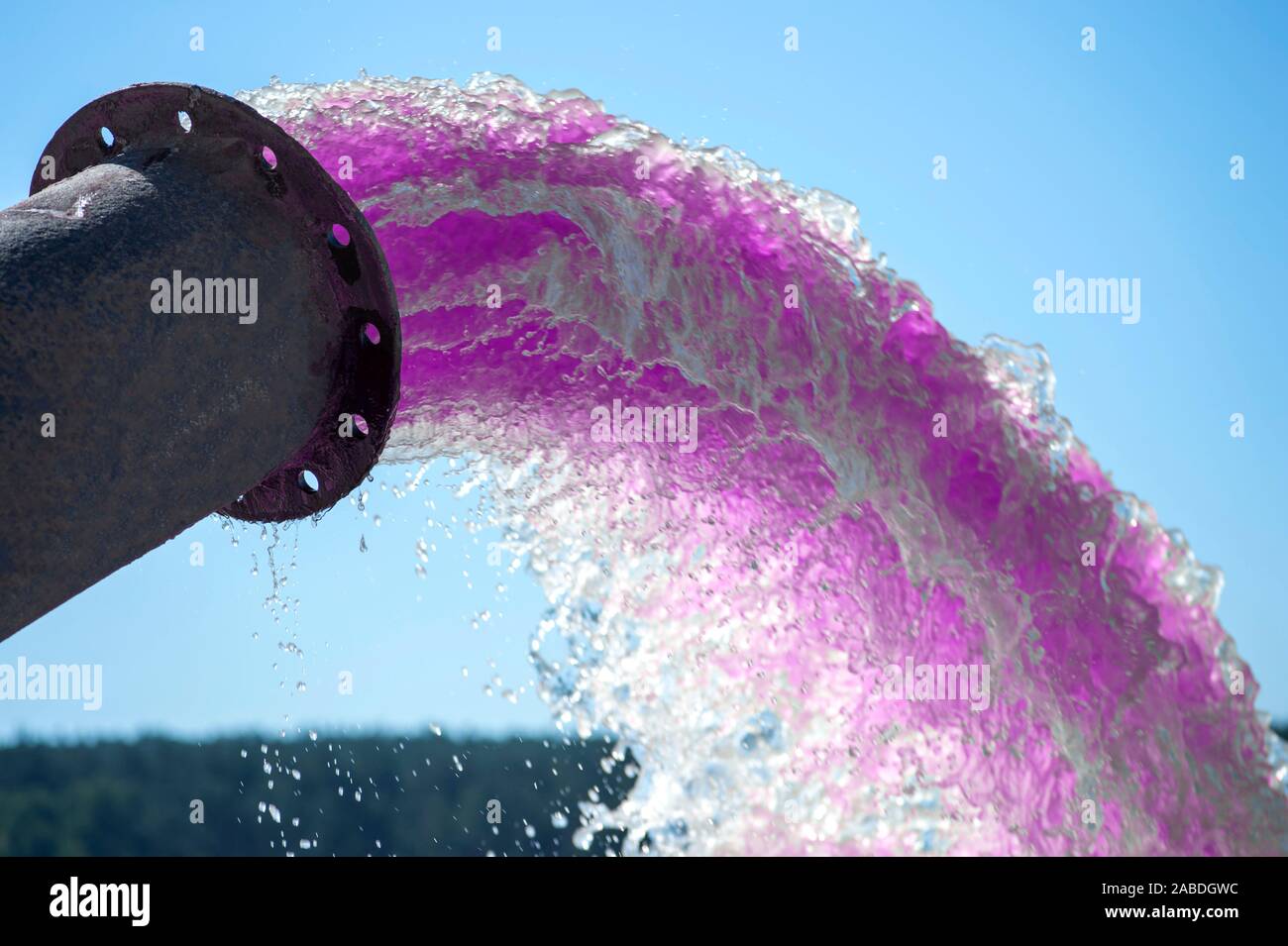 Reset the stream of water with a pink tint on the background of forest ...