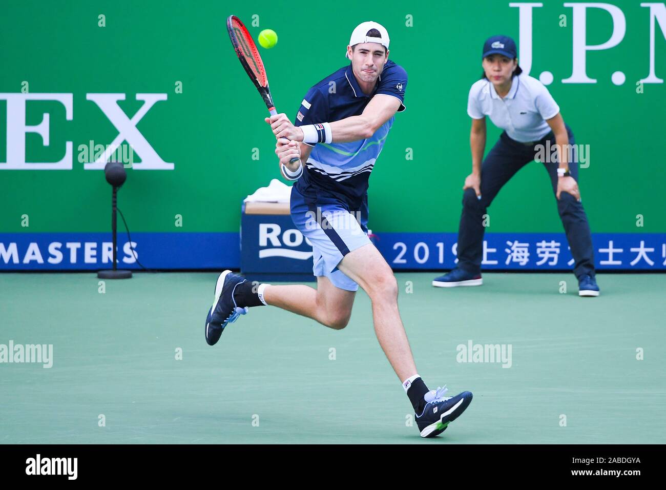 American professional tennis player John Isner competes against Serbian ...