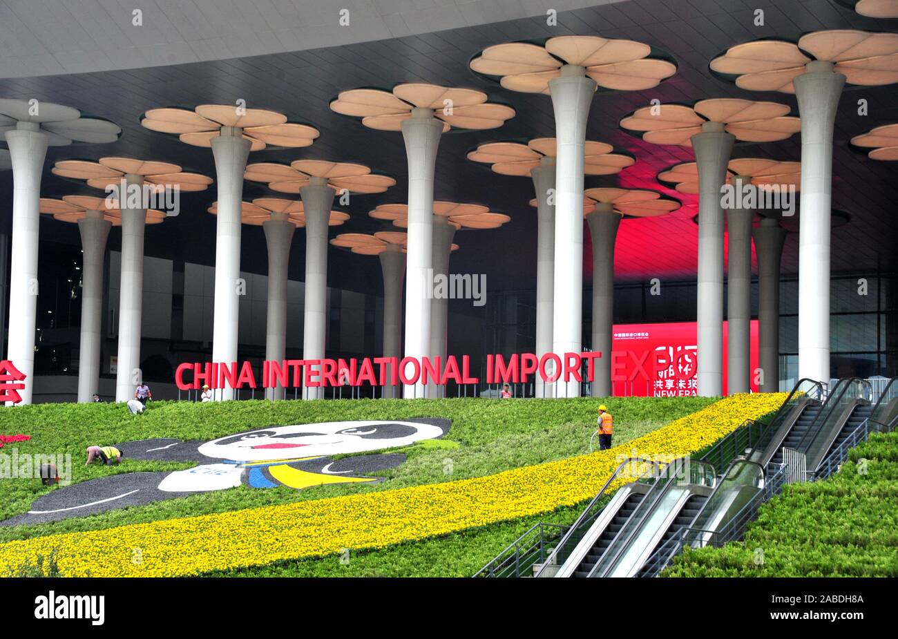 Construction workers water the mosaiculture outside the exhibition ...