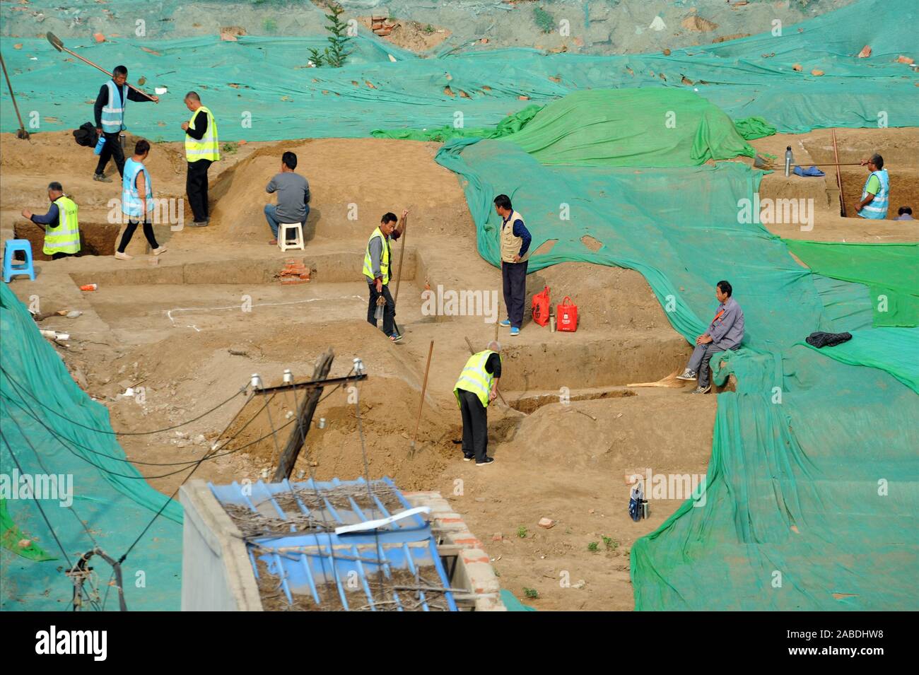 Chinese archaeologists excavate a tomb cluster at construction site of ...