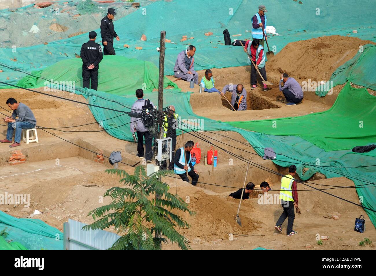Chinese archaeologists excavate a tomb cluster at construction site of ...