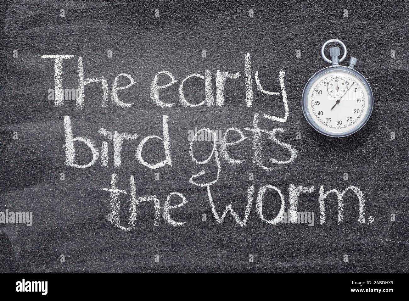 The early bird gets the worm English proverb written on chalkboard with ...