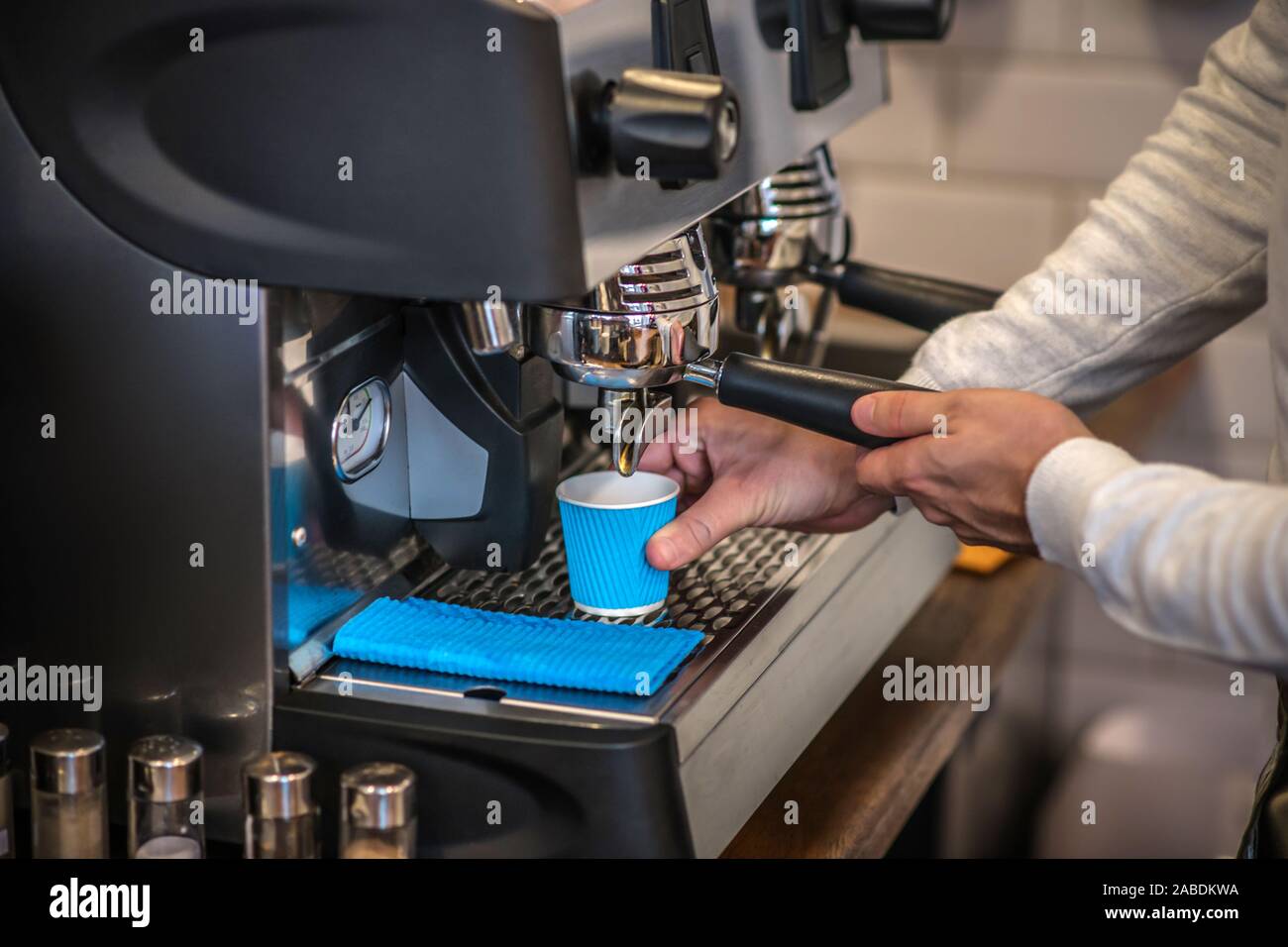 Barista using coffee machine while making coffee for customer Stock ...