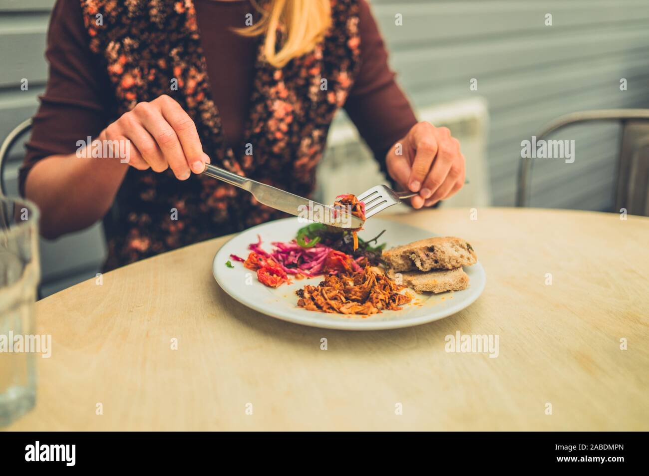 A young woman is eating dorian fruit in a cafe Stock Photo - Alamy