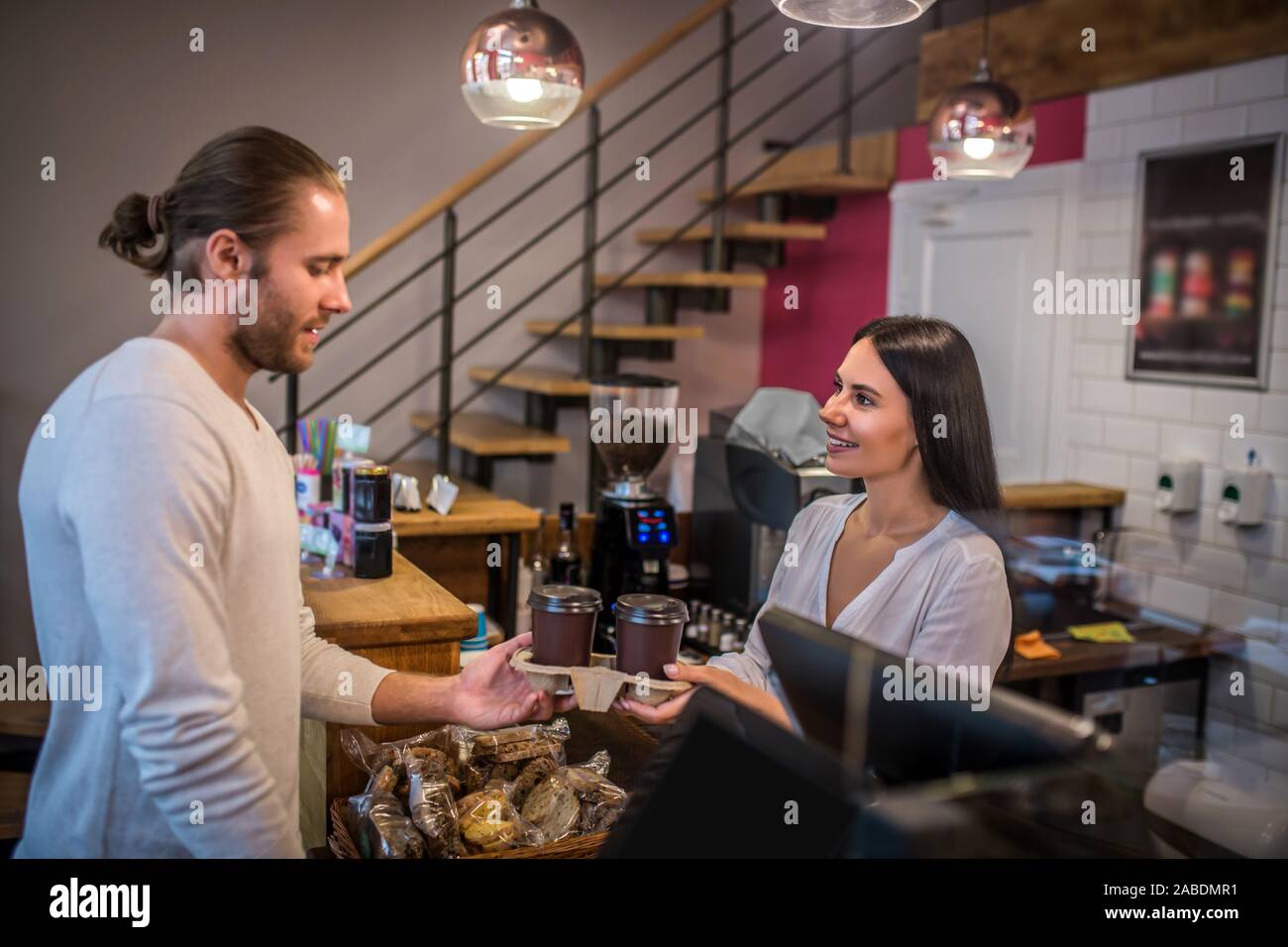 Bearded man getting takeaway coffee in favorite coffee shop Stock Photo ...