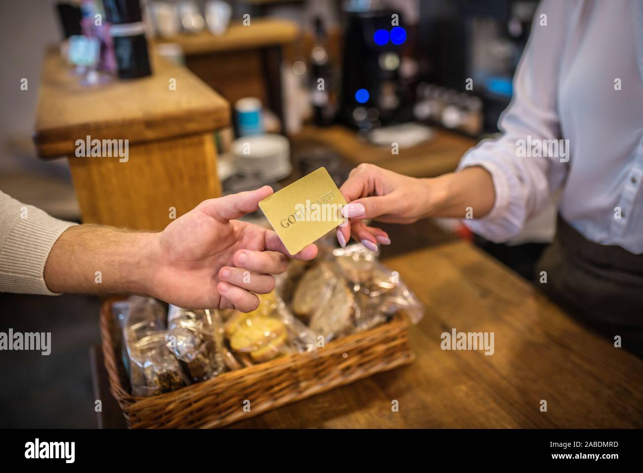 Cashier taking card while customer paying for order by card Stock Photo ...