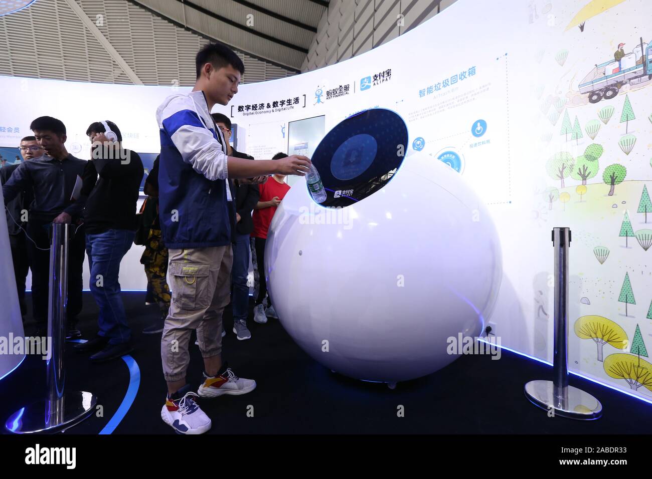 A visitor interacts with a smart garbage classification robot by ...